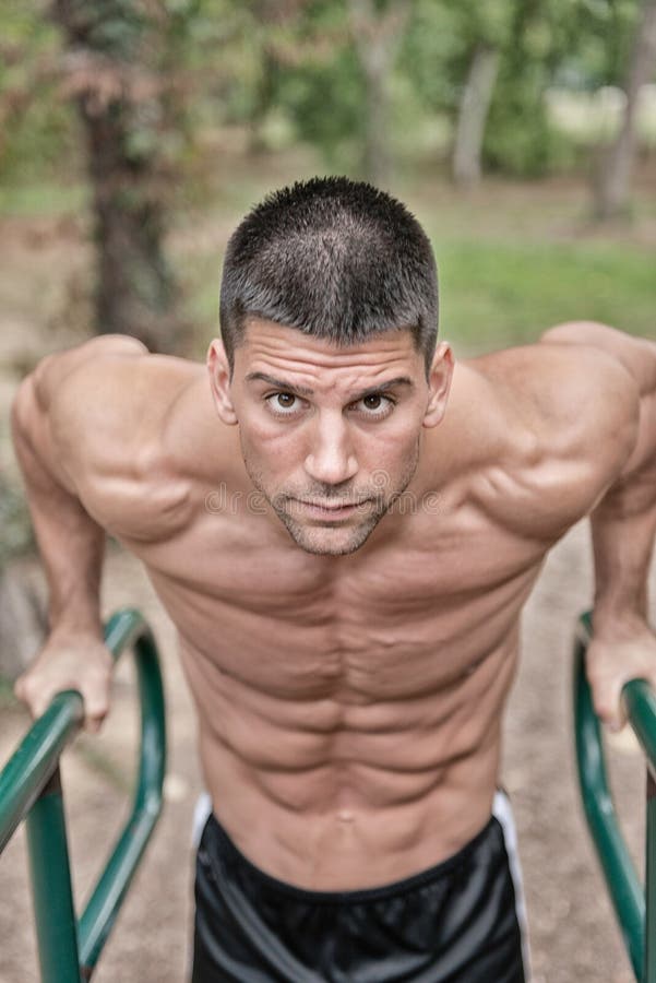 Exercising on Parallel Bars Stock Photo - Image of green, exercises ...