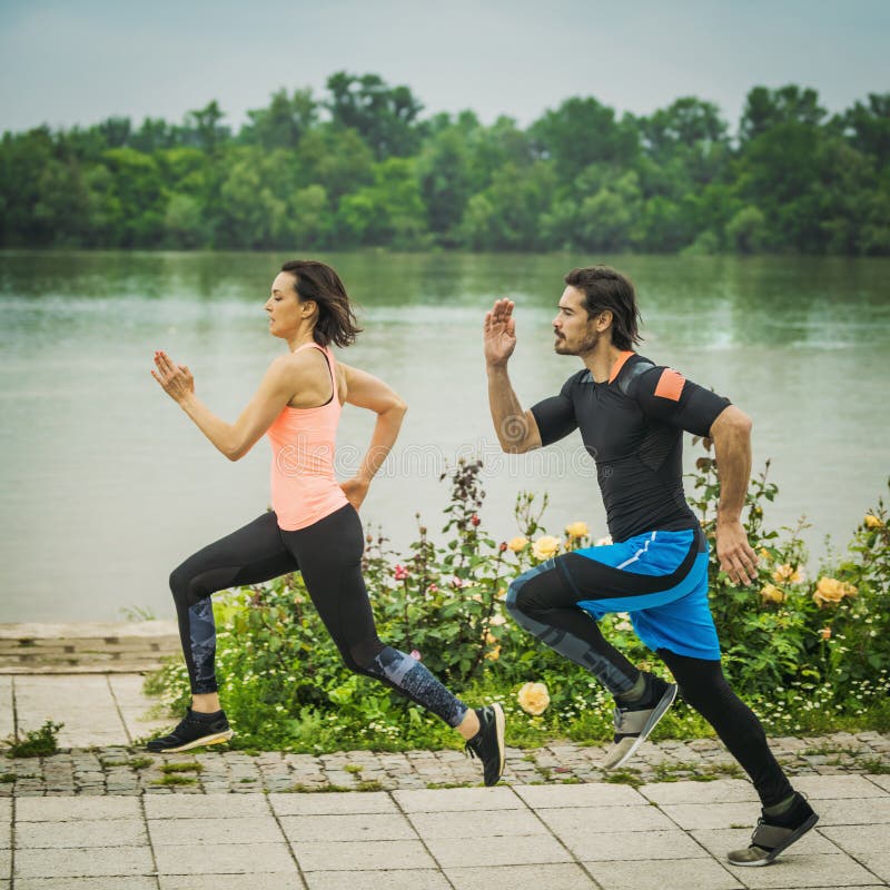 Fit Young Couple Jogging Outdoors Stock Image - Image of riverside ...