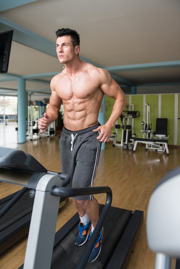 Exercising on a Treadmill stock image. Image of indoors - 58871035