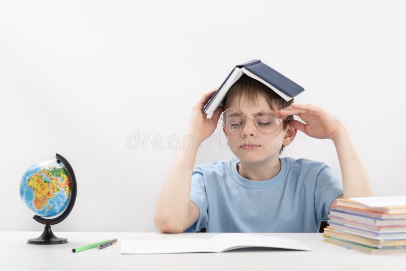 Exhausted Boy with Closed Eyes and Holds Open Book on His Head ...