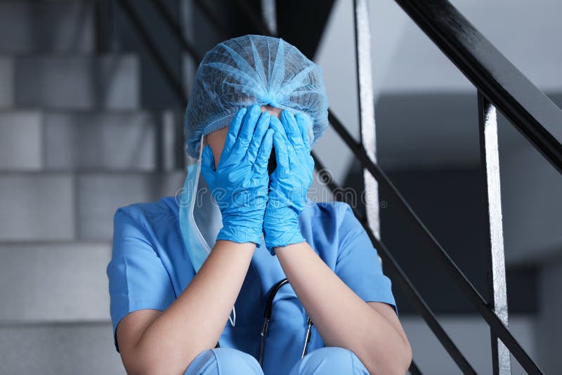 Exhausted Doctor Sitting on Stairs in Hospital Stock Photo - Image of ...
