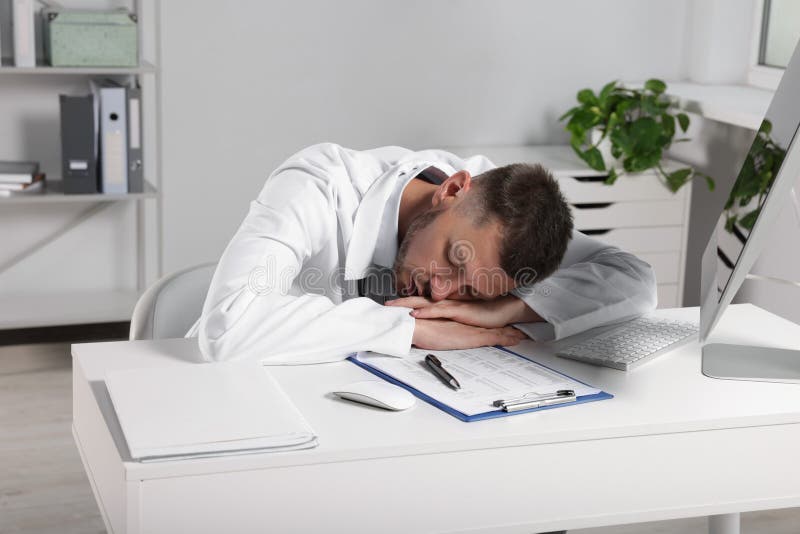 Exhausted Doctor Sleeping at Workplace in Hospital Stock Image - Image ...
