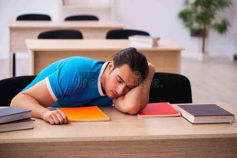 Exhausted Male Student Preparing for the Exams in the Classroom Stock ...