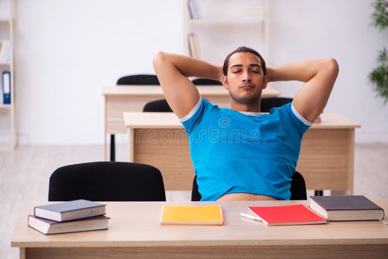 Exhausted Male Student Preparing for the Exams in the Classroom Stock ...