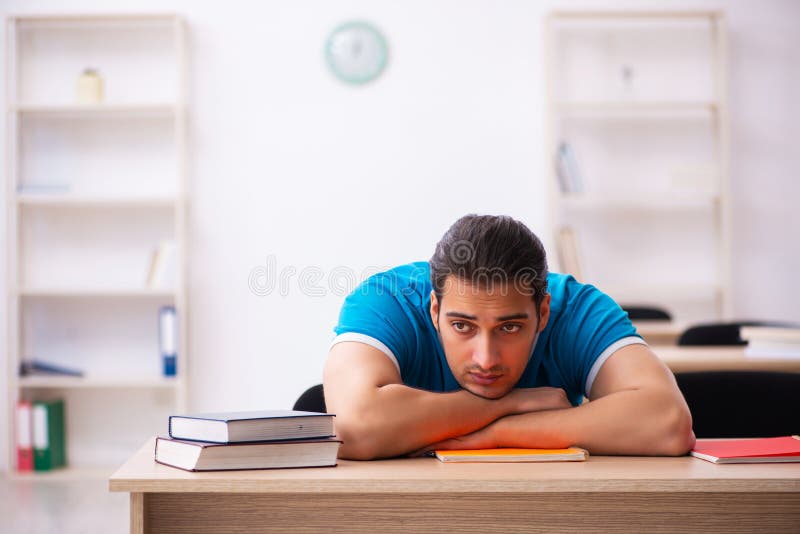 Exhausted Male Student Preparing for the Exams in the Classroom Stock ...