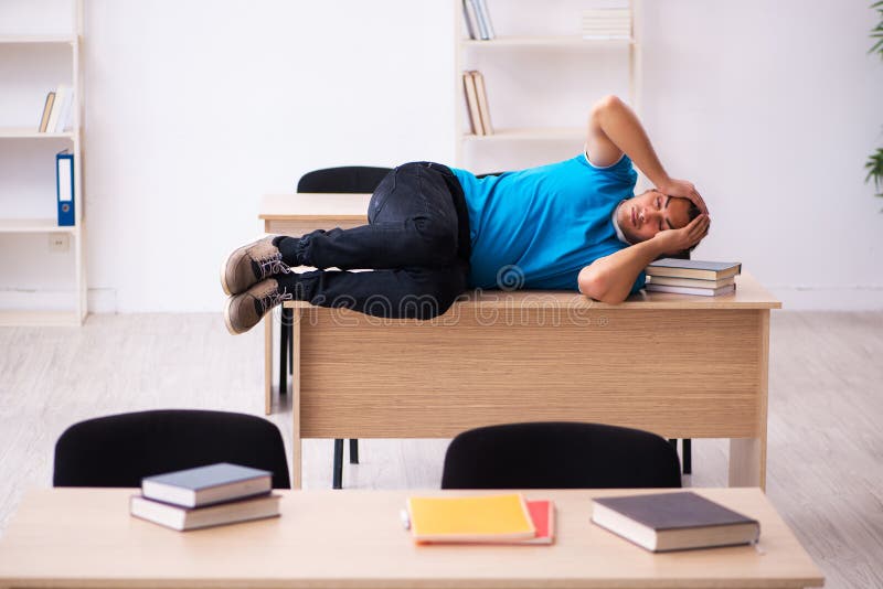 Exhausted Male Student Preparing for the Exams in the Classroom Stock ...