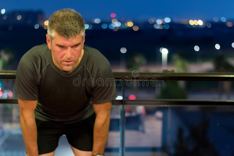 An Exhausted Man Rests after Running Stock Photo - Image of health ...