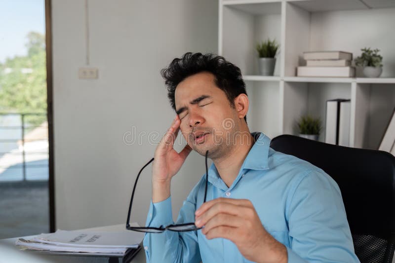 Exhausted Office Worker Experiencing Headache from Intense Workload in ...
