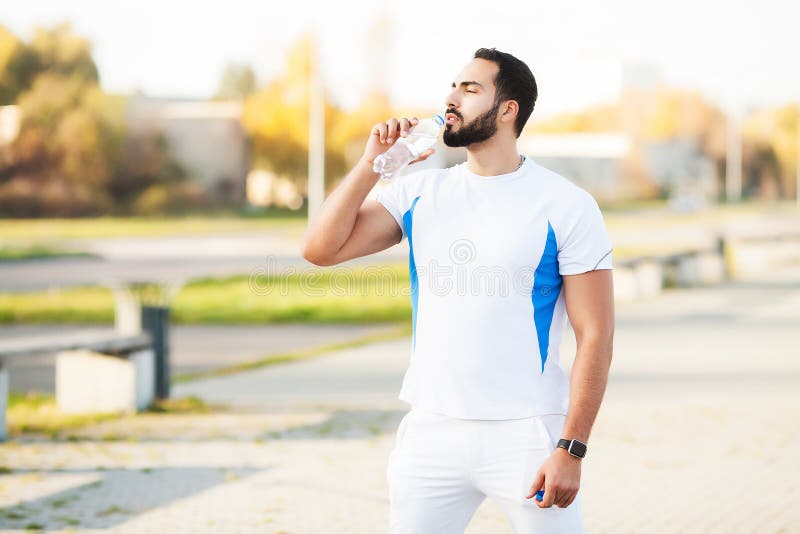 Exhausted Runner Man Drink Water on the Park after Workout Stock Photo ...