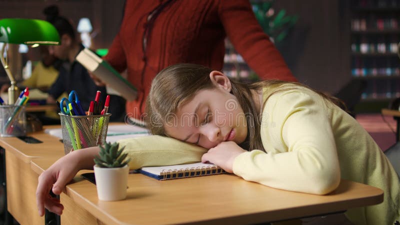 Exhausted Scholar Sleeping on Desk before Tutoring Session with a ...