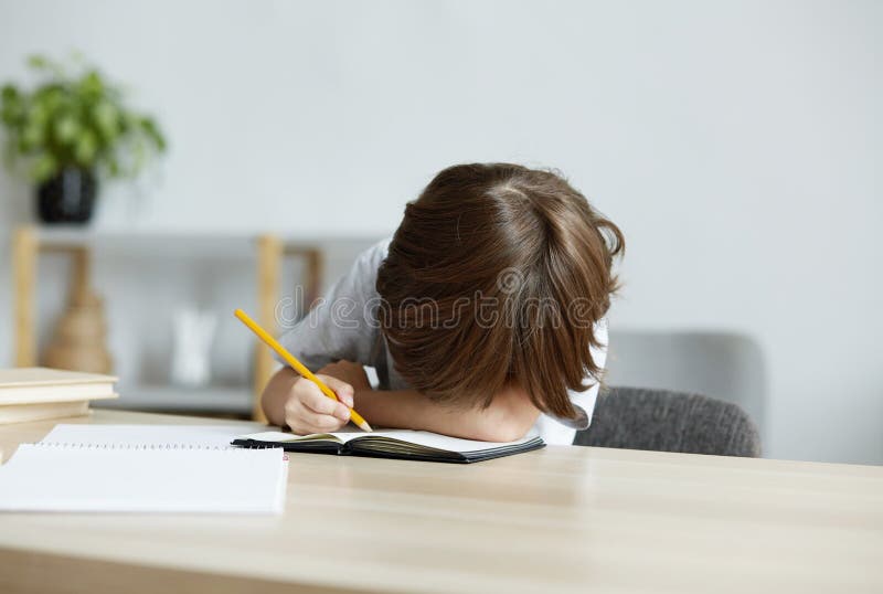 Exhausted School Kid is Tired from Homework and Learning and is Lying ...