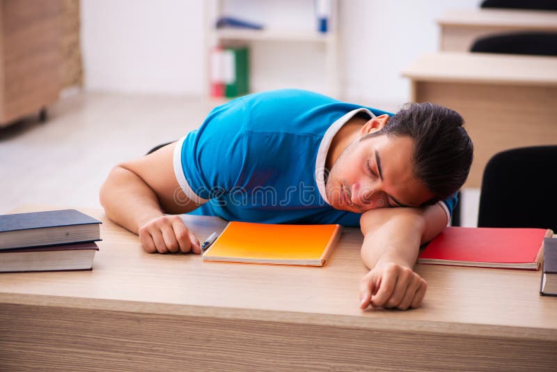 Exhausted Male Student Preparing for the Exams in the Classroom Stock ...