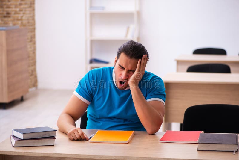 Exhausted Male Student Preparing for the Exams in the Classroom Stock ...