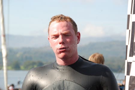 Exhausted swimmer editorial photo. Image of wetsuit, lake - 10915651