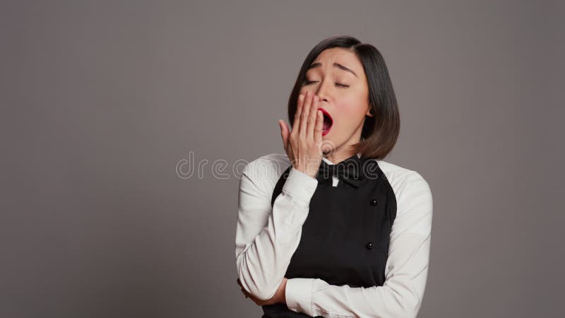 Exhausted Waitress with Apron Yawning Over Grey Background Stock Video ...