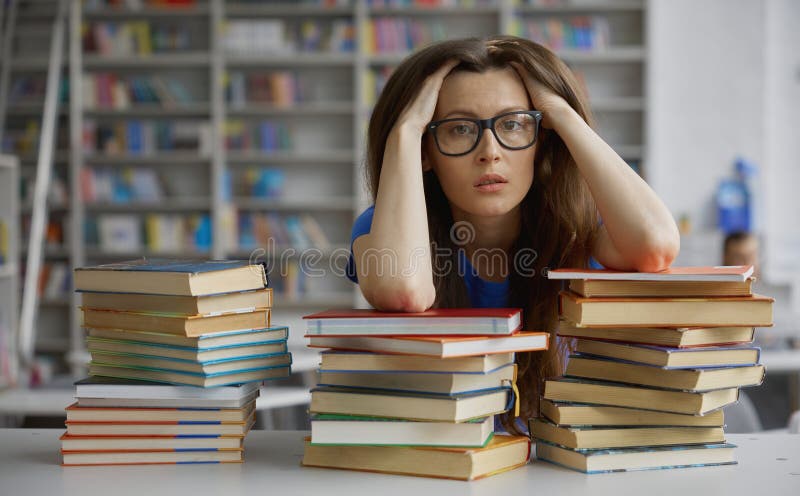Tired Woman Sitting Front of Huge Stack of Book in Library Stock Image ...