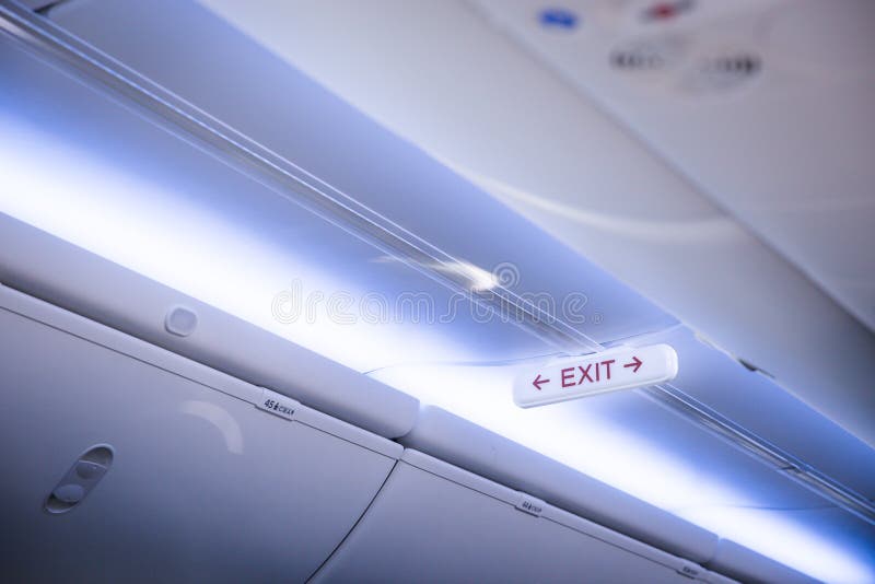 Exit Sign in in the Aircraft Cabin. Stock Image - Image of equipment ...
