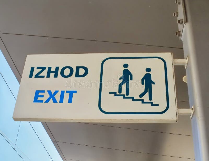Exit Sign with Icon and Bilingual Text Under Ceiling Outdoors Stock ...
