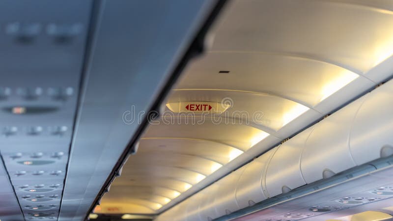 Exit Sign in Passenger Airplane. Emergency Exit Sign on Airplane Stock ...