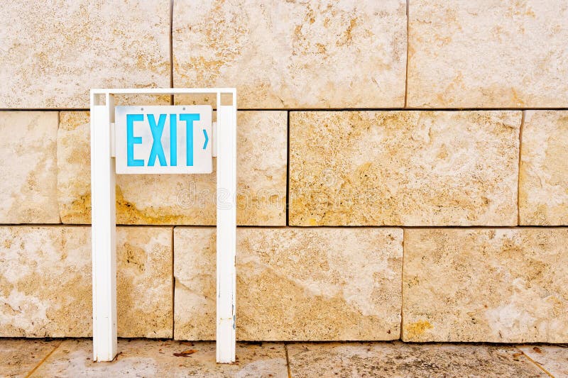 Exit Sign Placed in Front of a Stone Wall Stock Photo - Image of slab ...