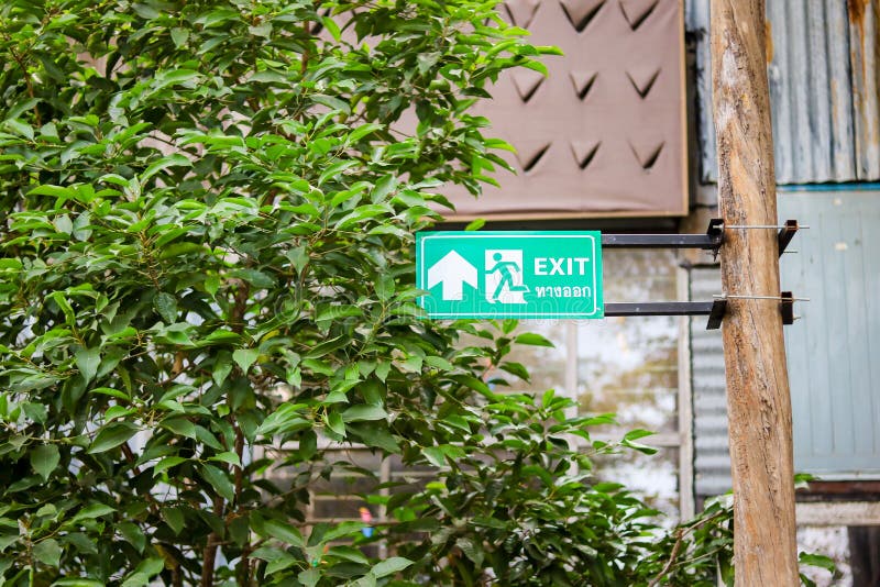 Exit sign on a wooden pole stock image. Image of street - 219520211