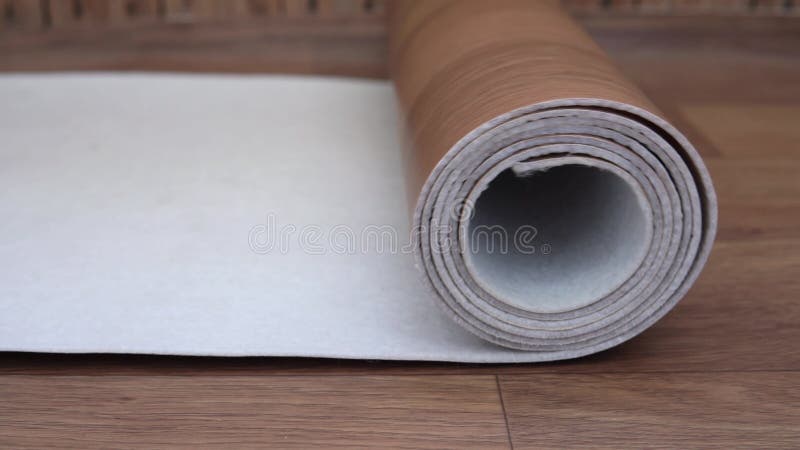 An Expanded Roll of Brown Linoleum Lies on the Floor. Linoleum with ...