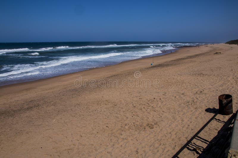 Expansive Beach Sand with Deep Blue Ocean and Clear Sky Stock Image ...