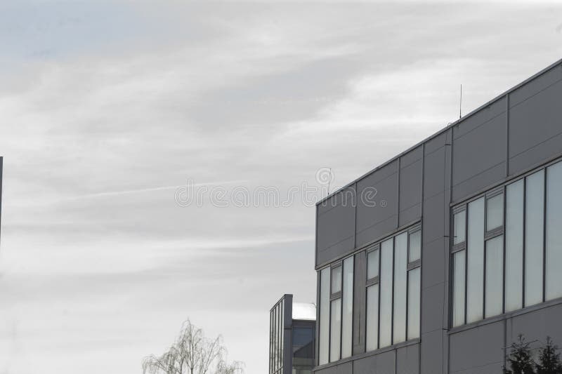 An Expansive Building Featuring Numerous Windows Seen on a Cloudy Day ...