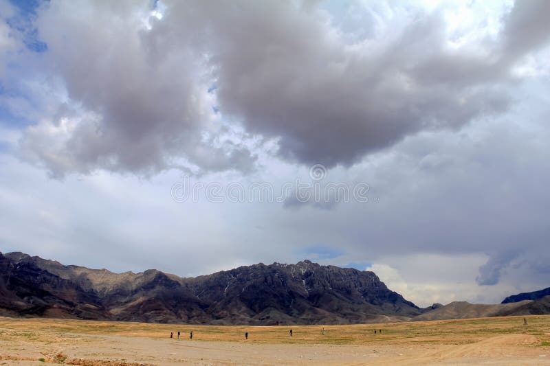 Expansive Desert Landscape with Dramatic Clouds and Distant Mountain ...