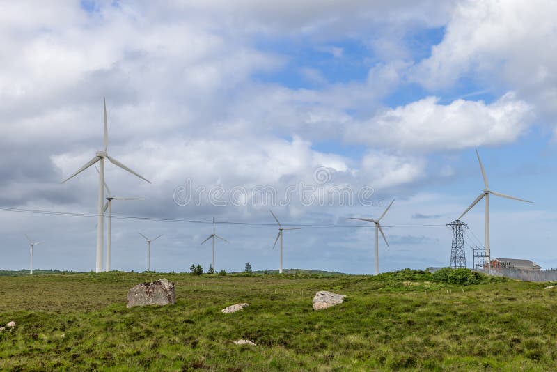Expansive Irish Fields Under Textured Clouds with Wind Turbines ...