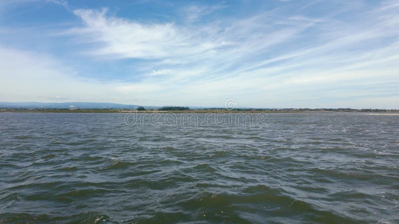 Expansive Lake View with Rippling Waters Under Wispy Clouds Stock ...