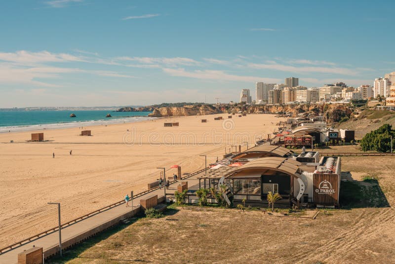 Expansive Sandy Beach with Modern Beachfront Structures, a Boardwalk ...