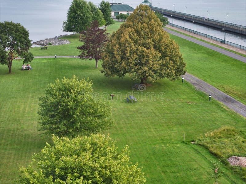 A View of an Open Grassy Field, a Dock and a Large Body of Water Stock ...