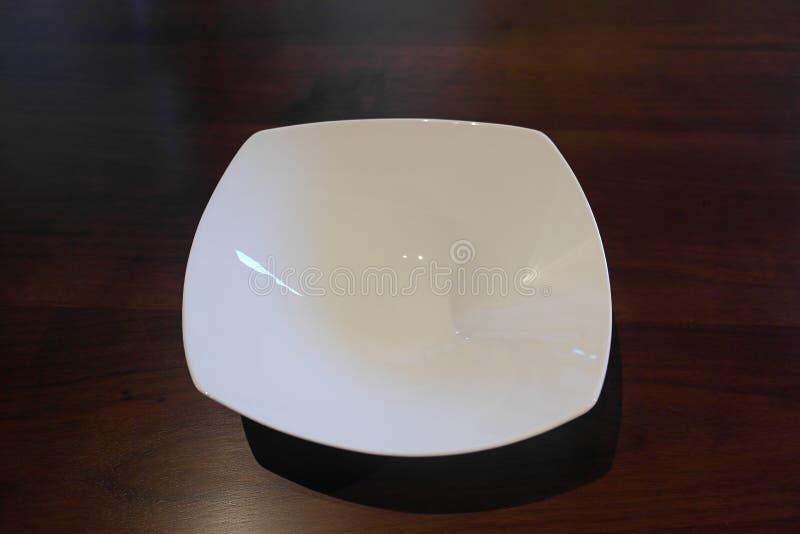 Expensive Square Shaped Luxury Porcelain Plate on an Oak Table Setting ...