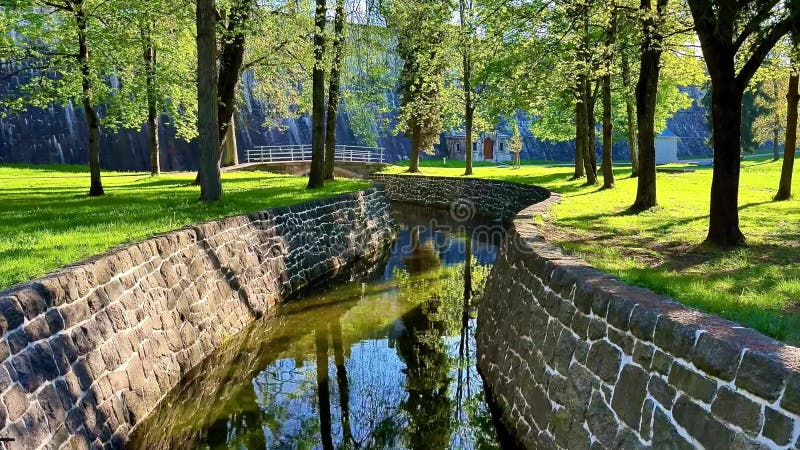 Experience the Serene Beauty of a Peaceful Park with a River Stock ...