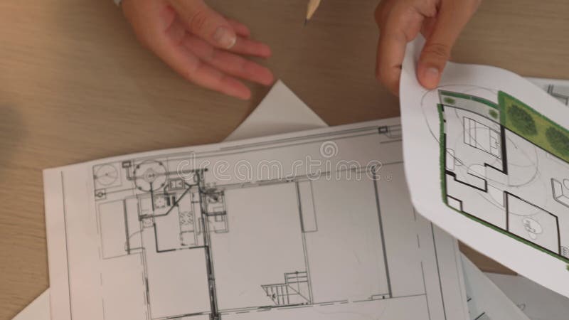 Experienced Architect Comparing the Blueprint on Messy Table ...
