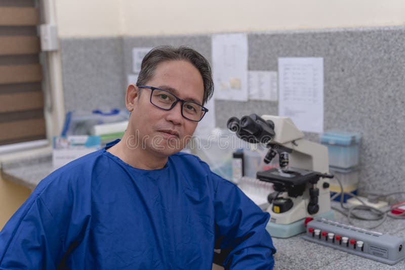 An Experienced Asian Male Laboratory Technician or Microbiologist ...