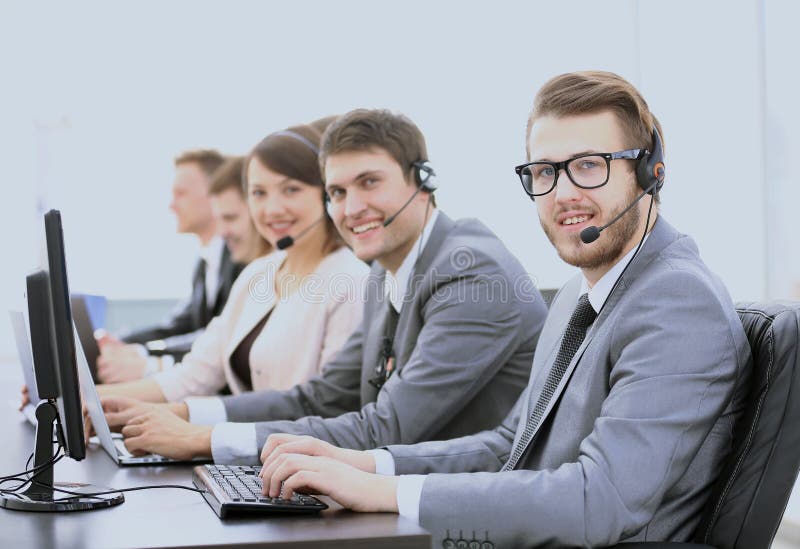 Experienced Assistants with a Headset in Front of Computers in T Stock ...