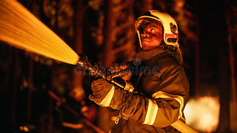 Experienced Back Firefighter Extinguishing a Wildland Fire Deep in a ...