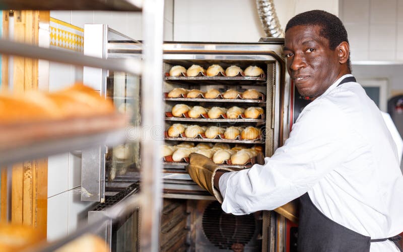 Baker Taking Out Bread from Oven Stock Photo - Image of food, indoors ...