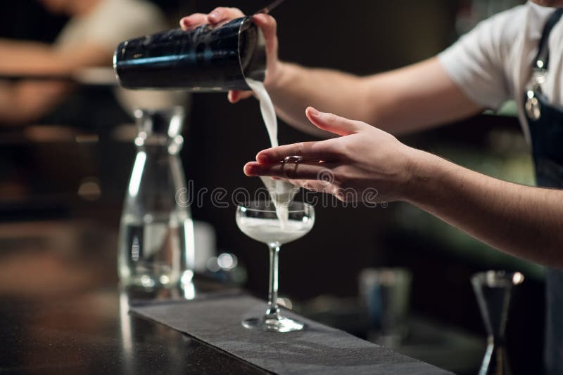 An Experienced Bartender Prepares an Alcoholic Cocktail. No Face, Close ...