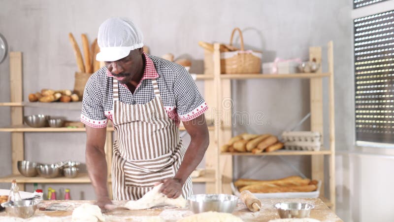 Experienced Black Baker in White Chef Uniform Kneading Pliable Dough on ...