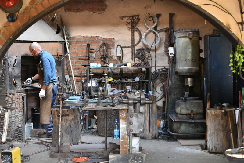 An Experienced Blacksmith Works with Open Fire. a Blacksmith ...