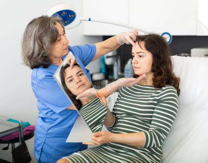 Experienced Cosmetology Doctor Examines Face A Young Woman Patient