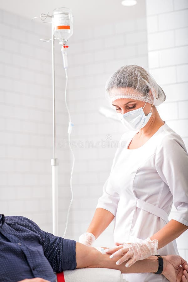 Experienced Doctor Preparing Drip for Patient Stock Photo - Image of ...