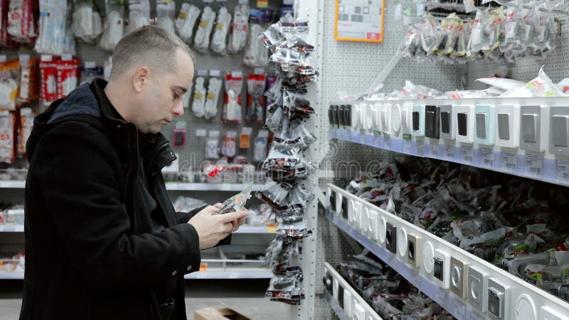 Experienced Electrician Checking Light Switch Label in Hardware Store ...