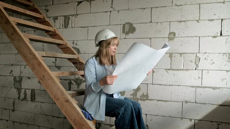 Experienced Engineer Reading Blueprints Inside Building Under ...