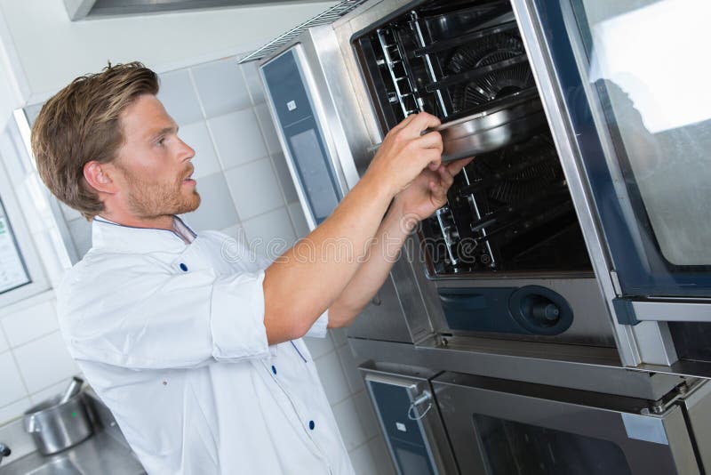 Experienced Handsome Chef Putting Dish in Oven Stock Photo - Image of ...