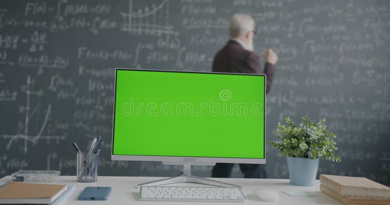 Experienced High School Professor Walking in Classroom Looking at ...