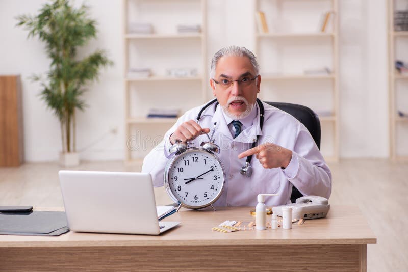 Experienced Male Doctor in Time Management Concept Stock Photo - Image ...